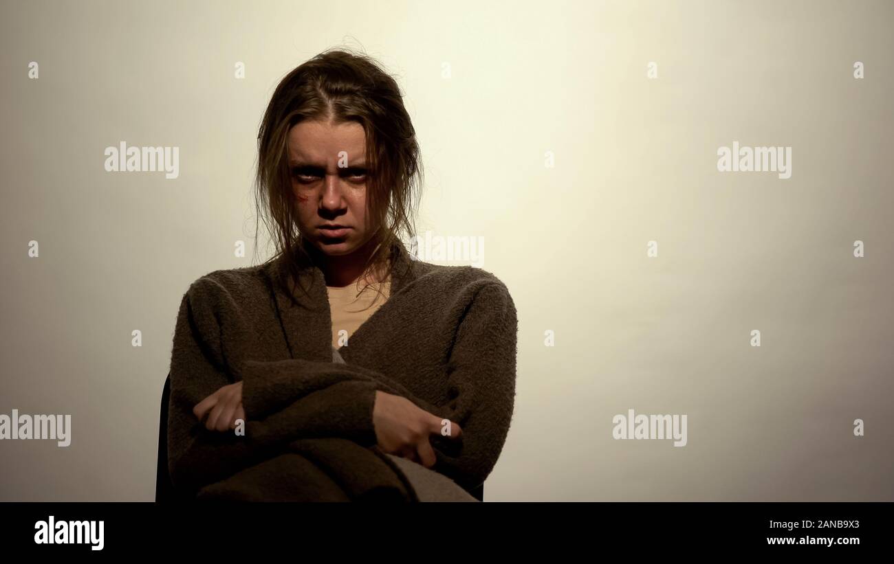 Frightened violence victim looking in camera on white background ...