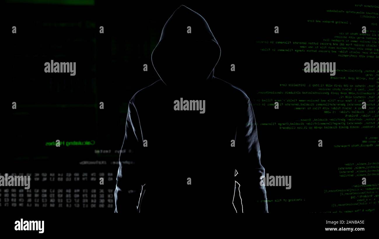 Silhouette of fearless male hacker standing on animated computer code ...