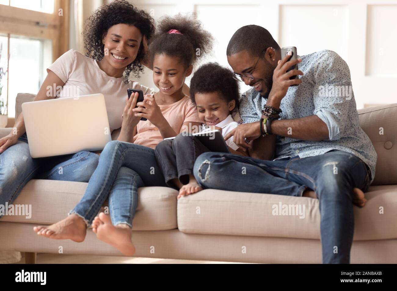 Family using different technology hi-res stock photography and images ...