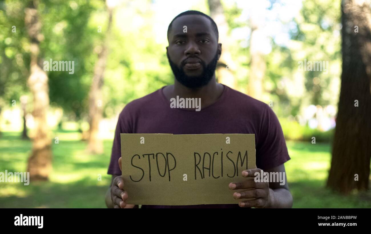 African man showing stop racism sign, national problem, equal rights ...