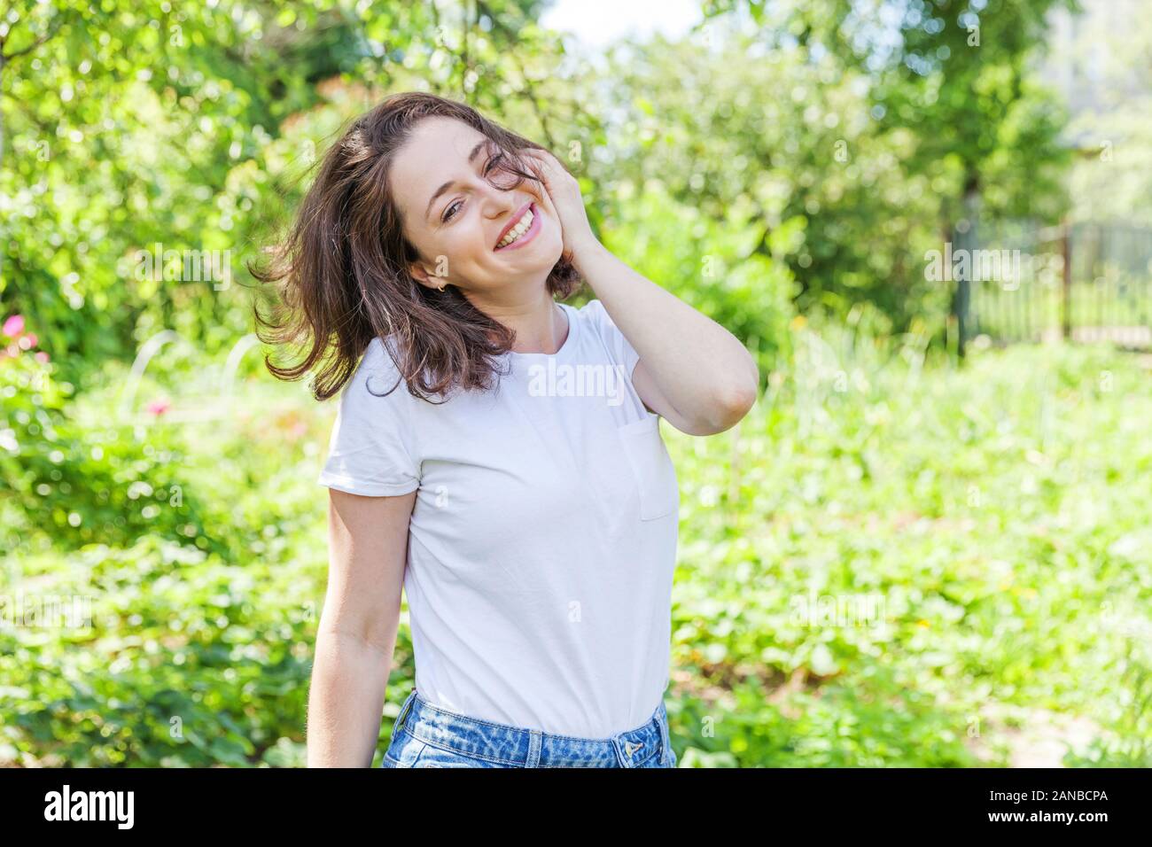 Happy girl smiling outdoor. Beautiful young brunete woman with brown ...