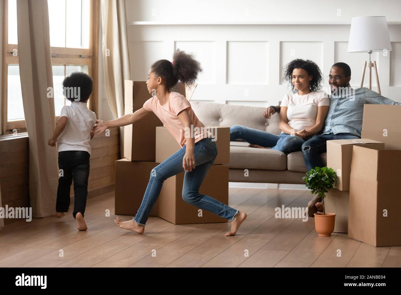 Two little happy black kids catching each other Stock Photo - Alamy