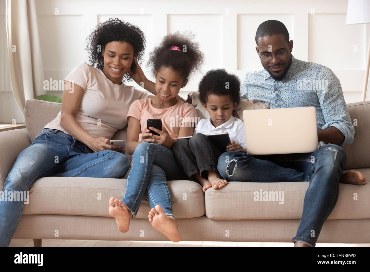 Happy black family addicted to internet technology Stock Photo - Alamy