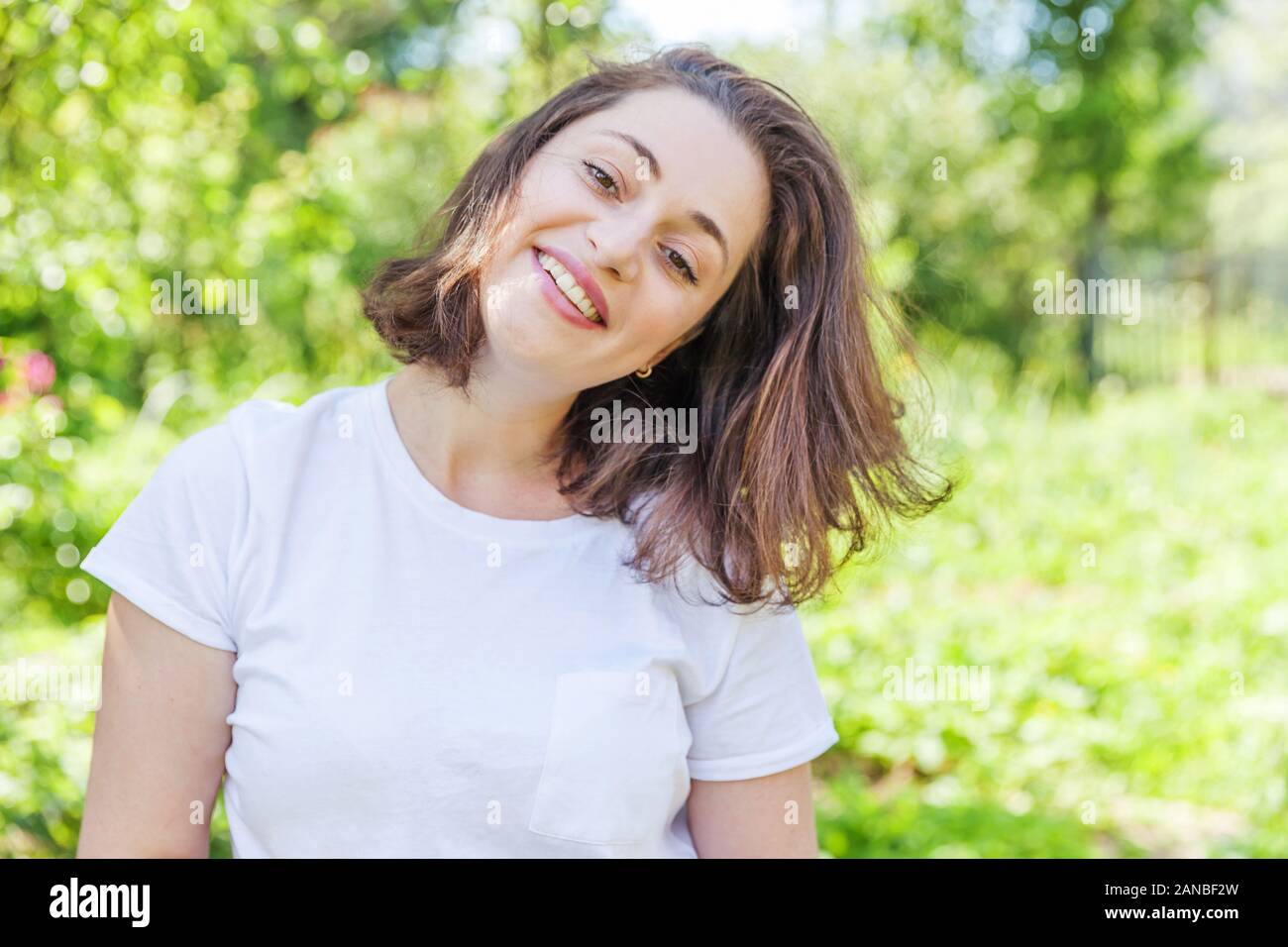 Happy girl smiling outdoor. Beautiful young brunete woman with brown ...