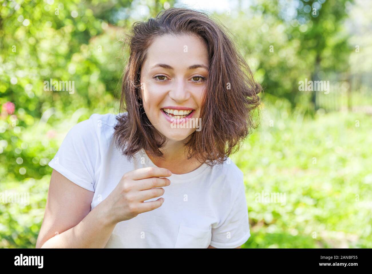 Happy girl smiling outdoor. Beautiful young brunete woman with brown ...