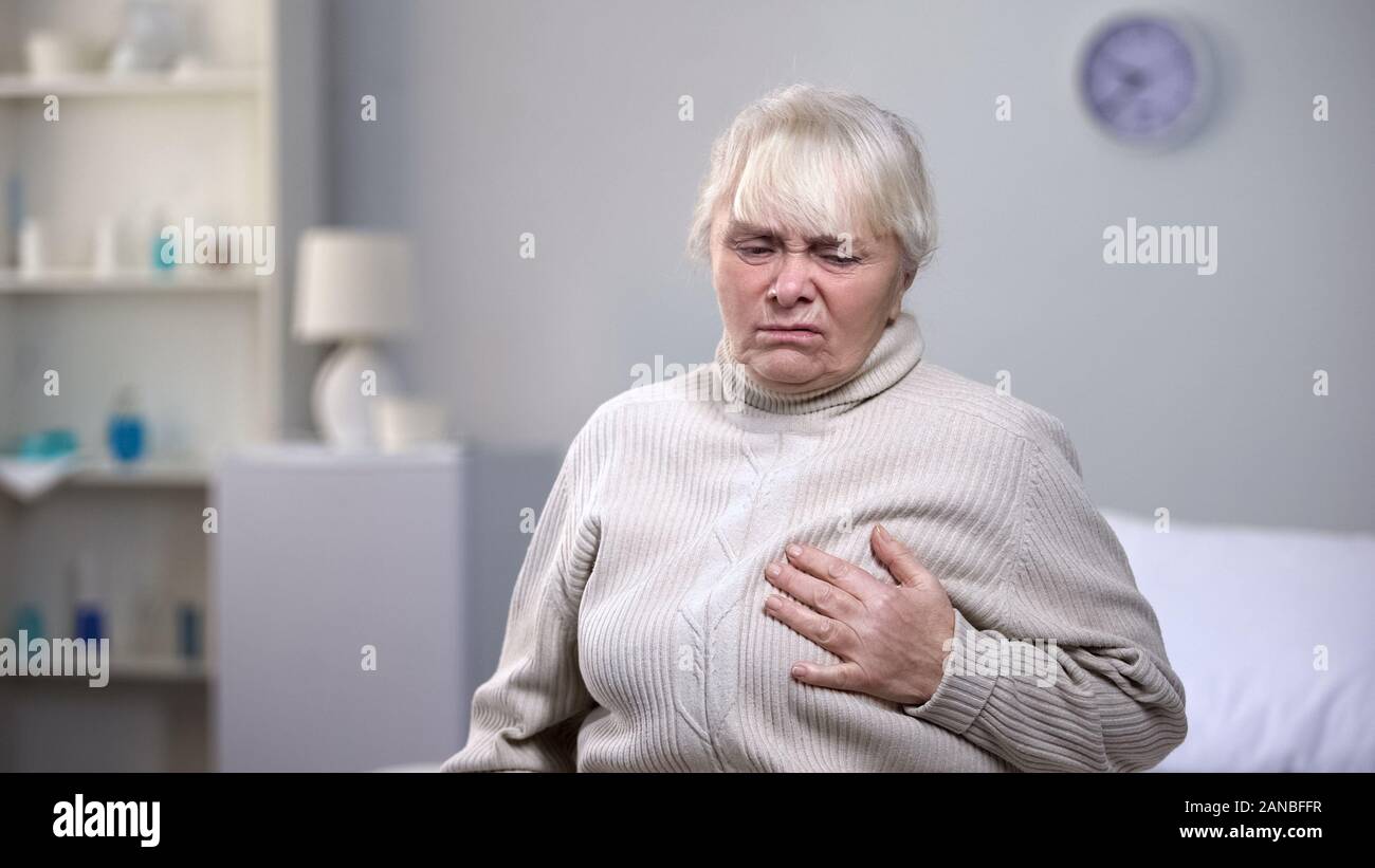 Elderly woman suddenly feeling heart attack, health problems in old age ...