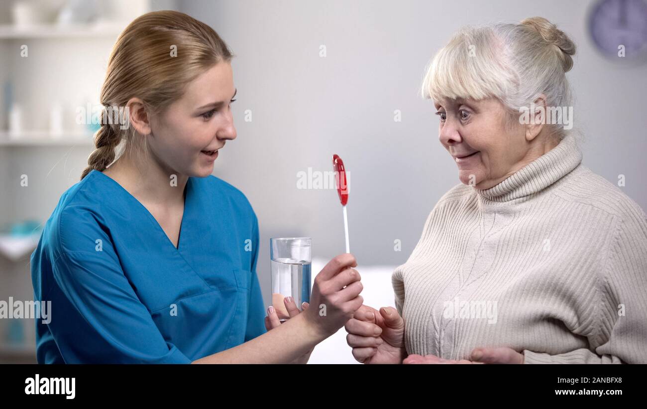 Female doctor giving candy hi-res stock photography and images - Alamy