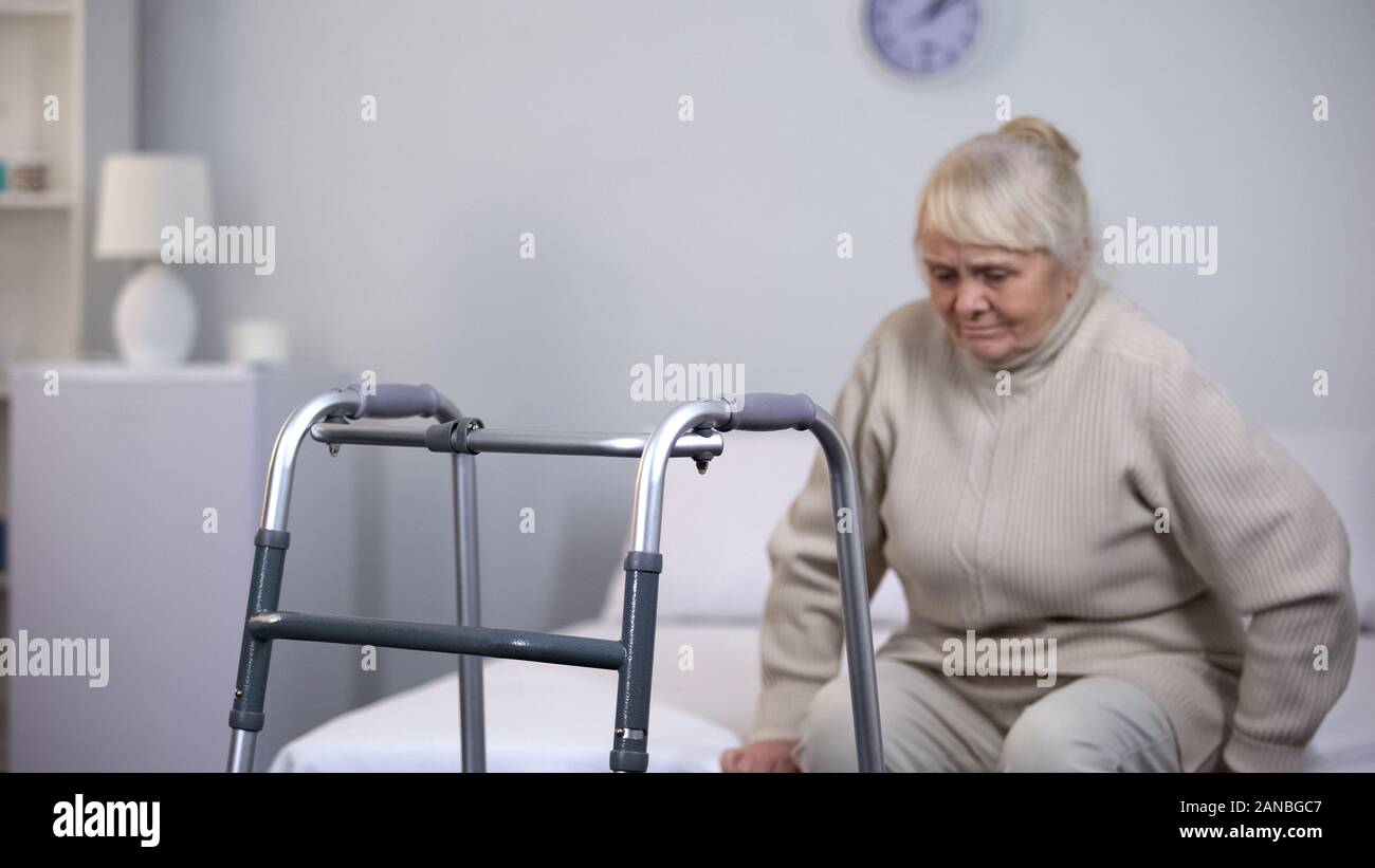 Walking frame front of female hospital patient, clinic rehabilitation ...