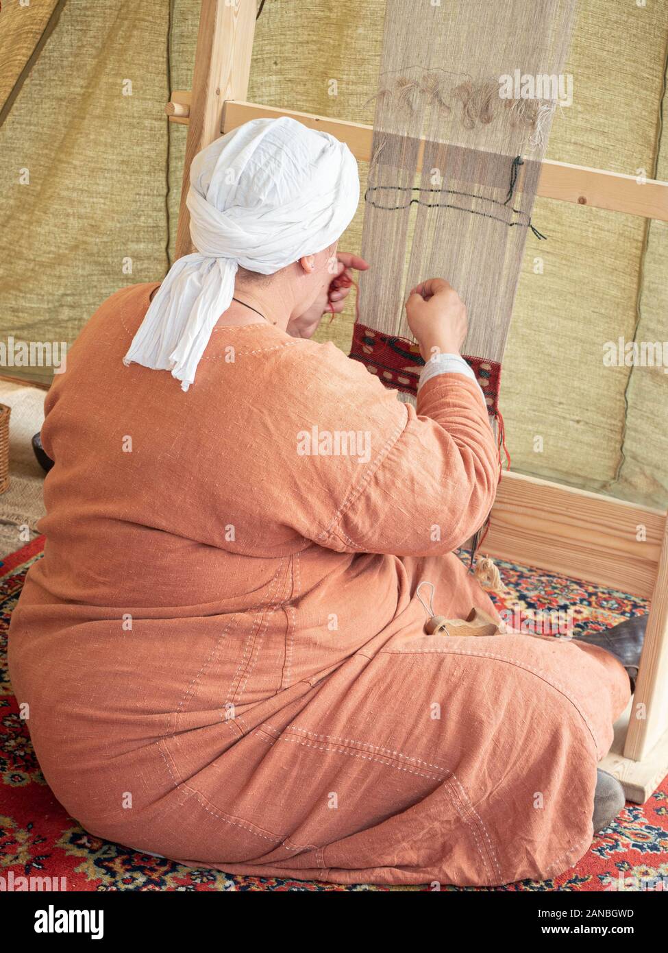 Times and Epochs Festival. Female Weaver Weaves a Canvas With a Pattern ...
