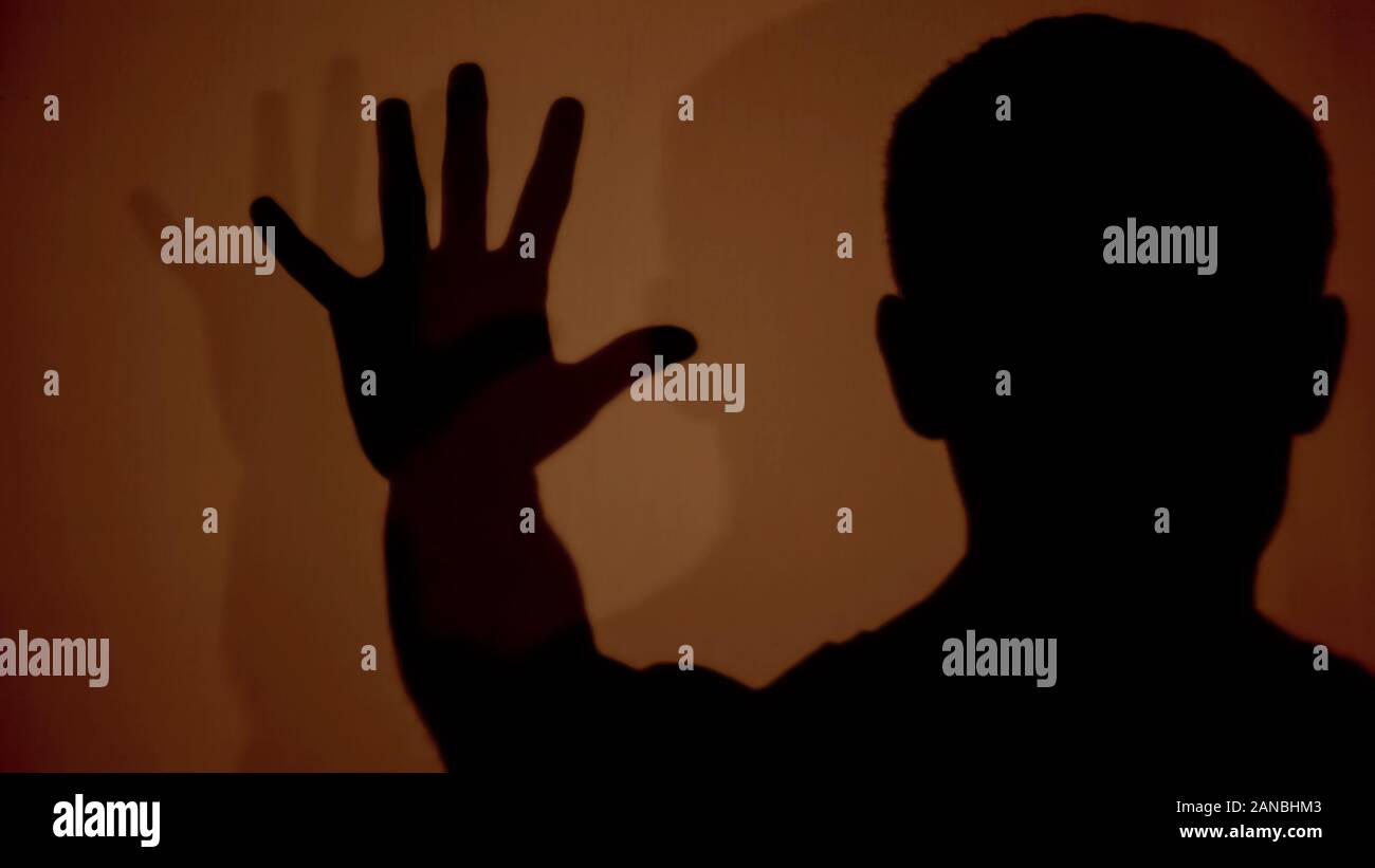 Male shadow showing stop gesture, protesting against aggression and ...