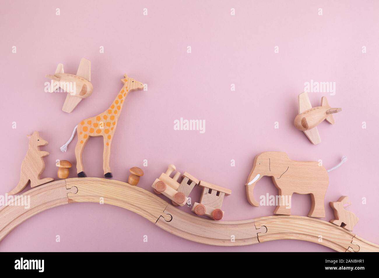 Zero waste. Eco wooden toys on pink background. Flat lay. Top view ...