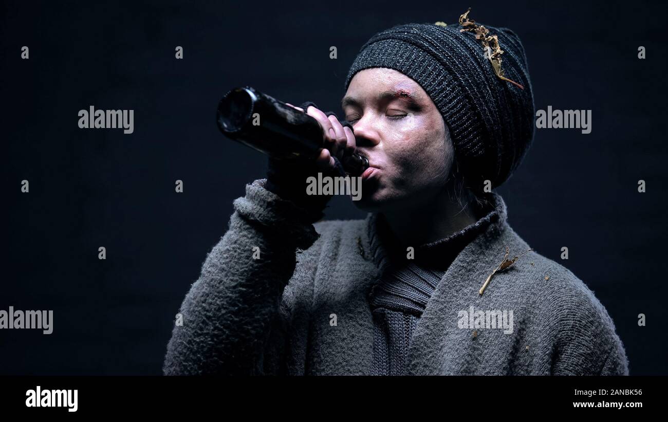 Homeless woman drinking beer from bottle, alcohol addiction, living on ...