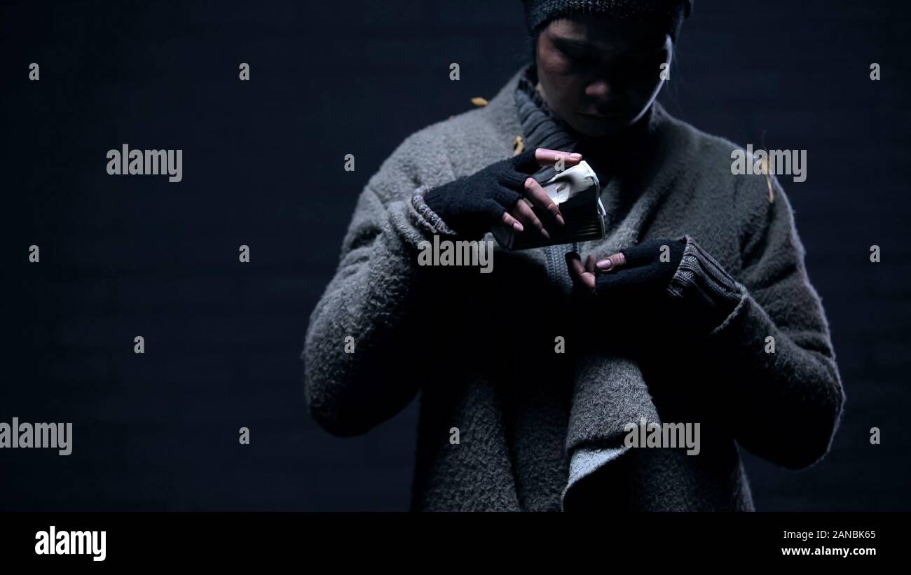 Poor refugee counting coins from paper cup, beggar living on street ...