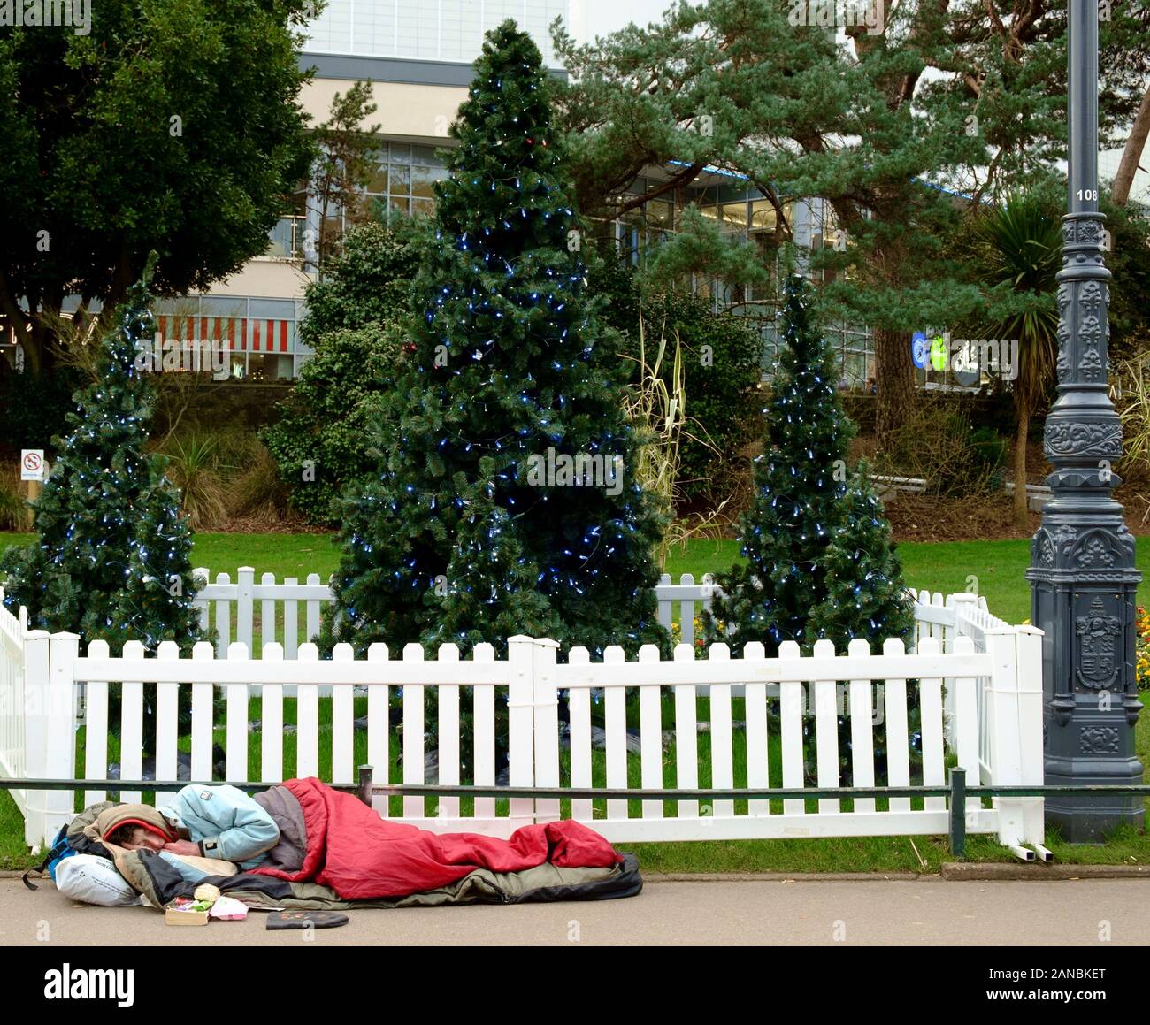 A homeless person sleeps next to a Christmas tree in Bournemouth's ...
