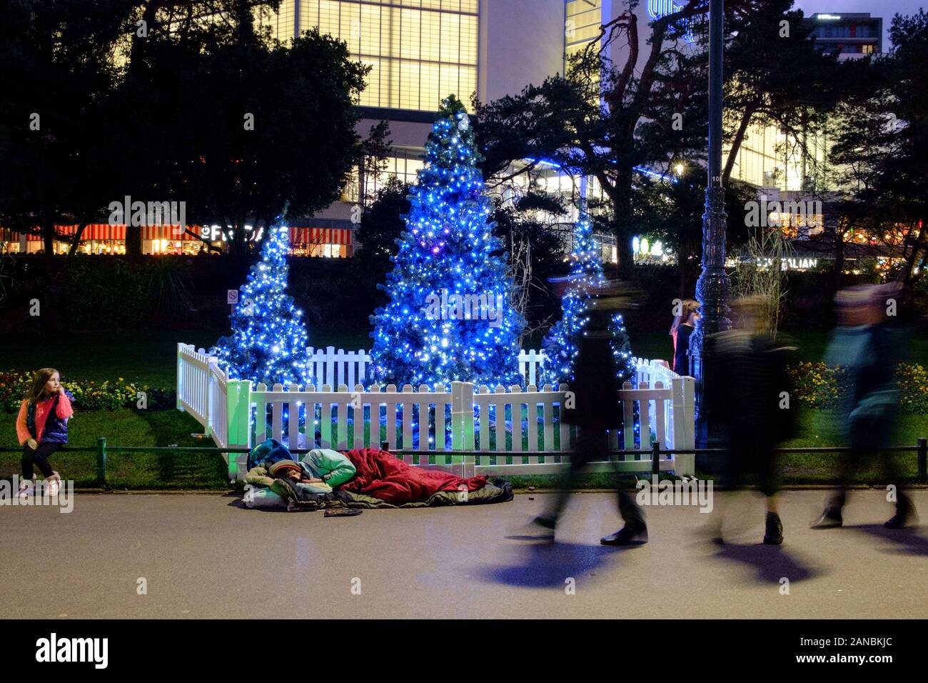 A homeless person sleeps next to a Christmas tree in Bournemouth's ...