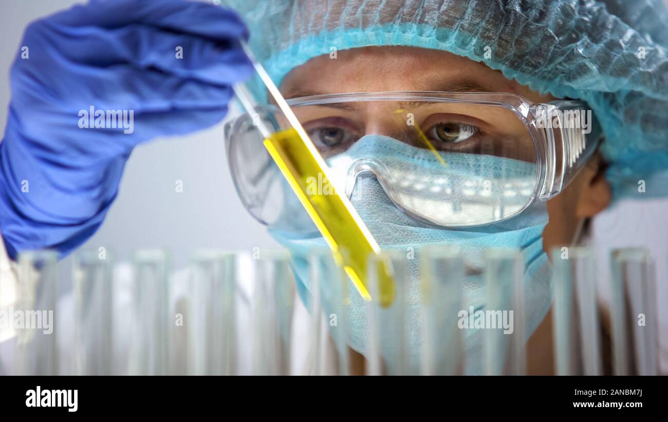 Researcher analyzing test tube with petrol sample, checking product ...