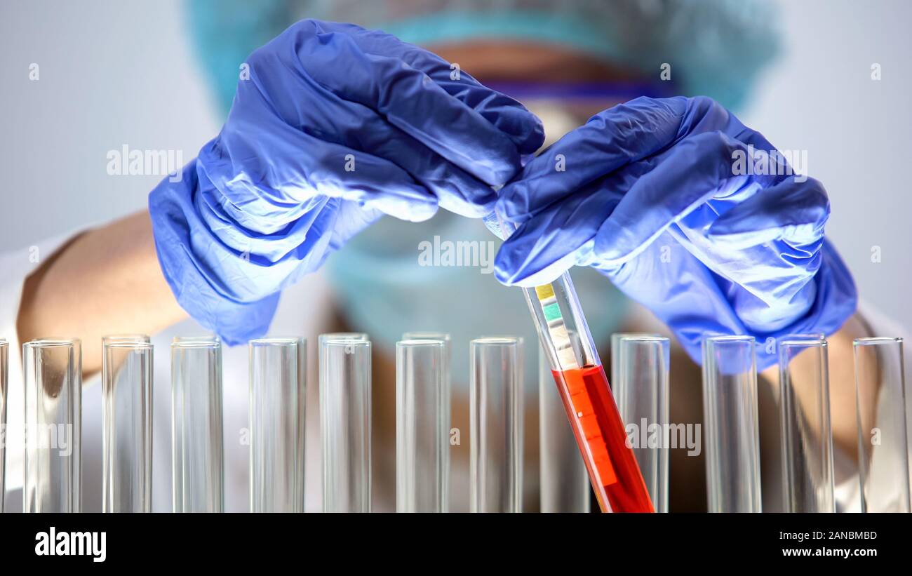 Chemical scientist putting litmus paper test tube, measuring pH level ...