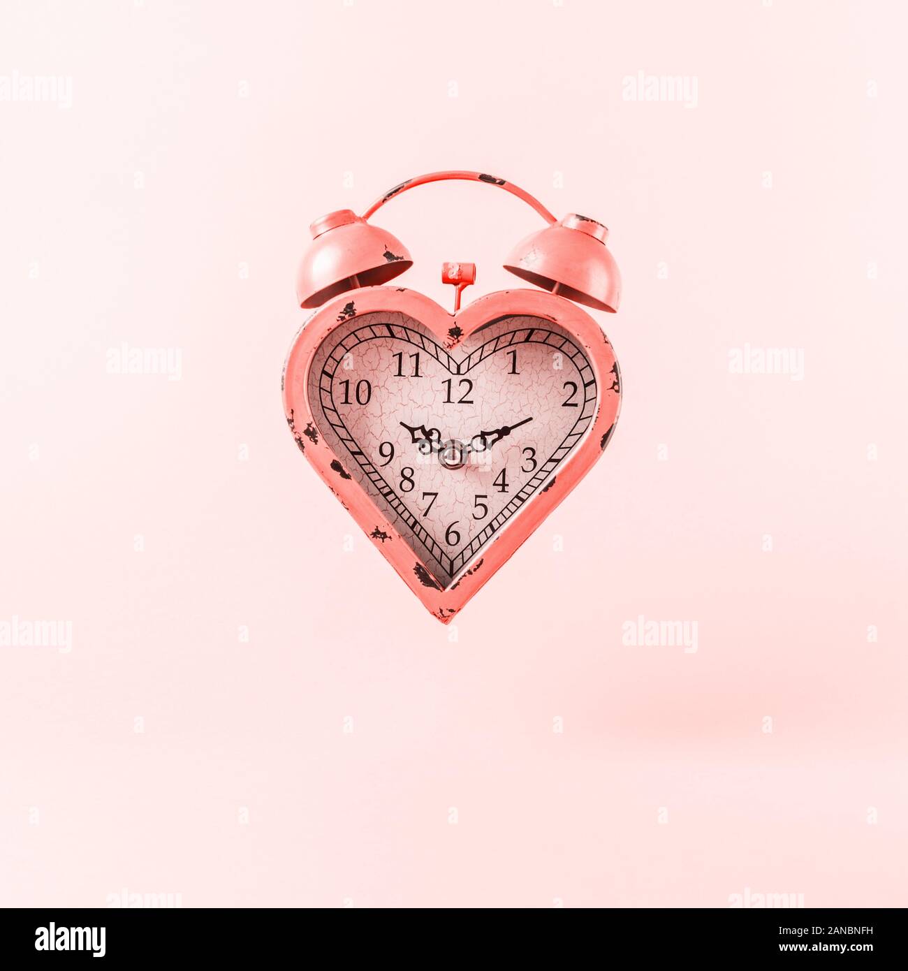 Heart shaped clock on pink background. Valentines day and love infitity ...