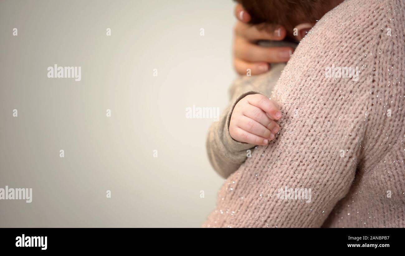 Baby mother cuddling baby arms hi-res stock photography and images - Alamy