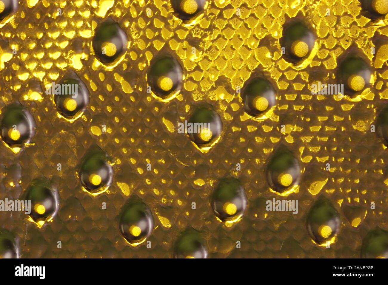 abstract colour image showing scattered light through textured glass ...