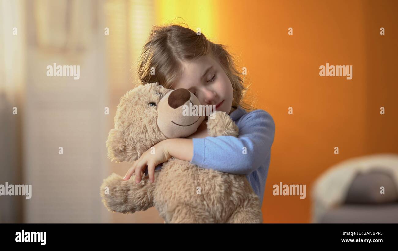 Little lonely girl hugging teddy bear, suffering loneliness, family ...