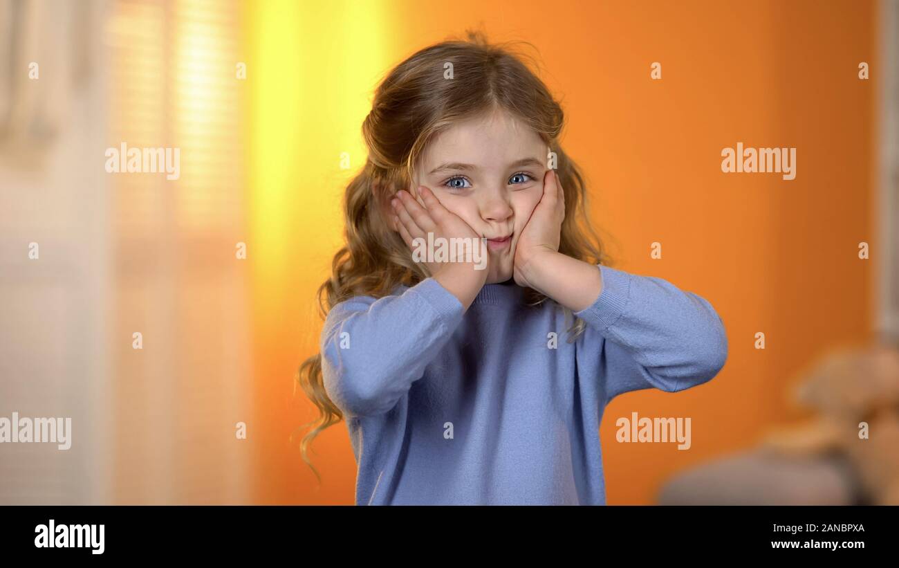 Cute little princess playing and making funny face to camera, healthy ...