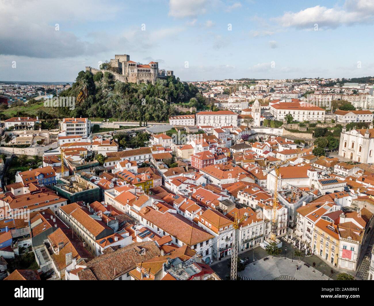 Aerial view of Leiria with castle on the hill and red roofs of downtown ...