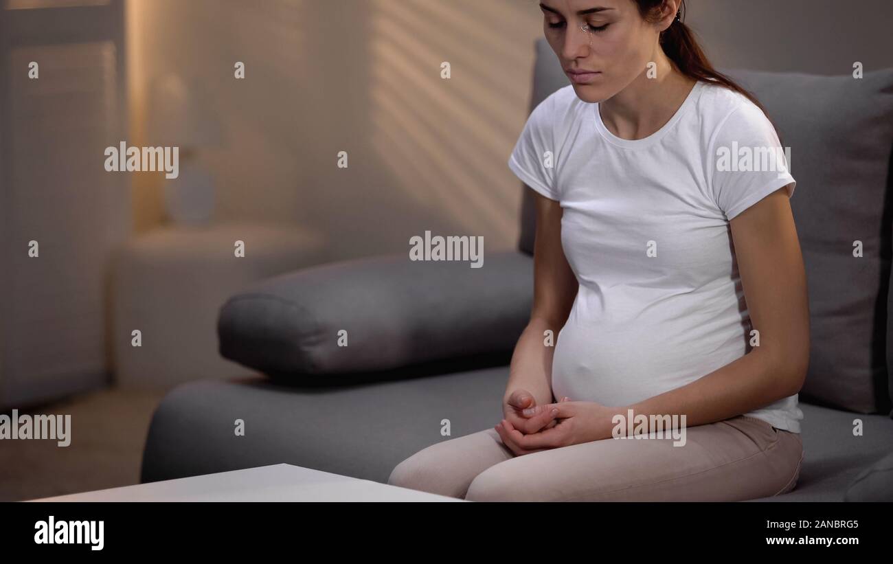 Upset pregnant refugee crying in camp for asylum seekers, poverty and ...