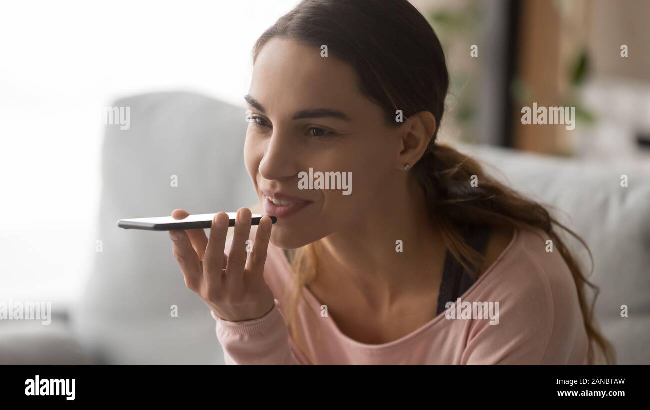 Millennial woman holding mobile phone, recording audio message Stock ...