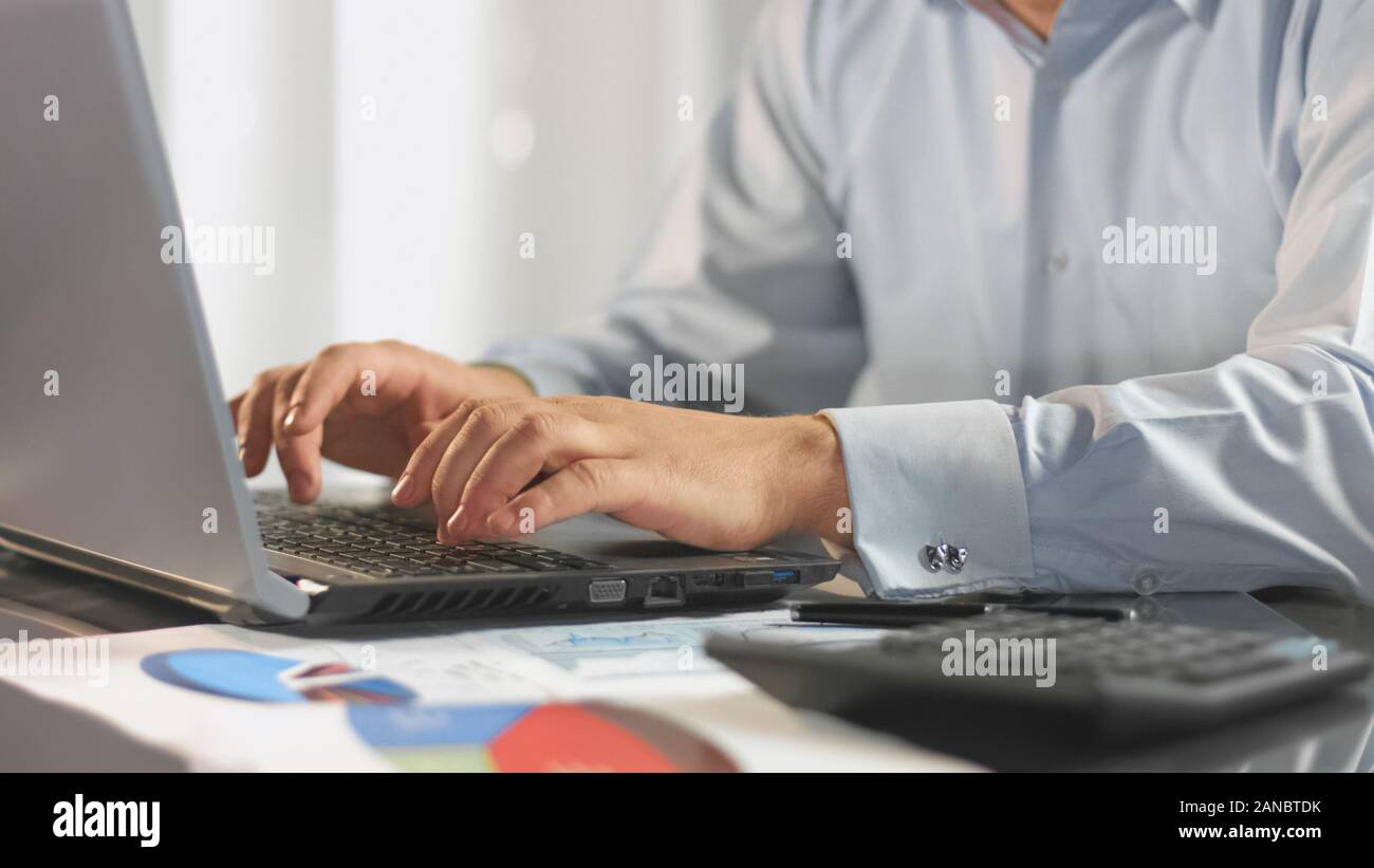 Business analyst working laptop, inserting calculated data, office work ...