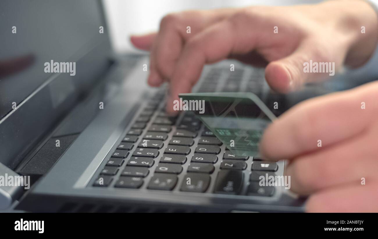 Hand typing laptop inserting bank card number, shopping online, payment ...