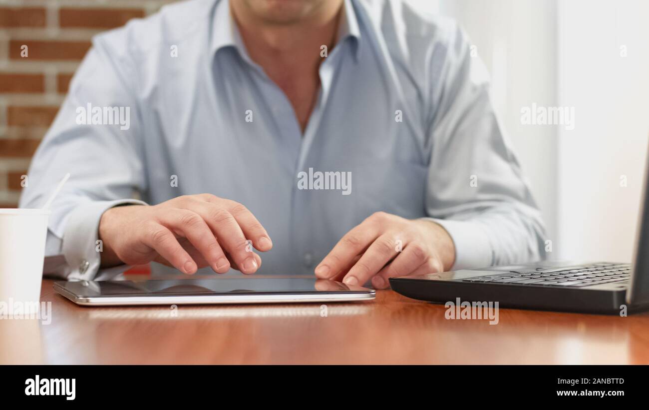 Man scrolling tablet screen preparing hi-res stock photography and ...
