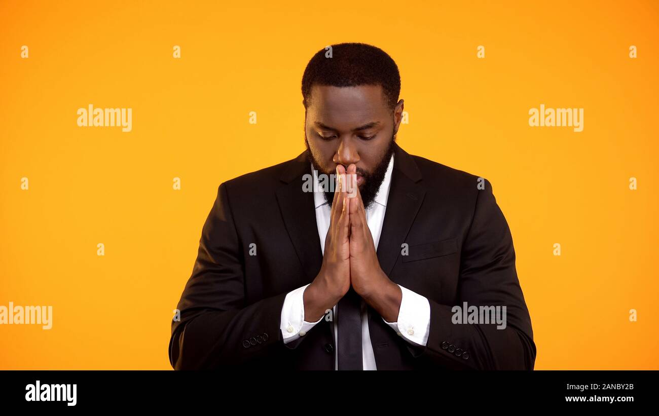 Man in suit praying looking hi-res stock photography and images - Alamy