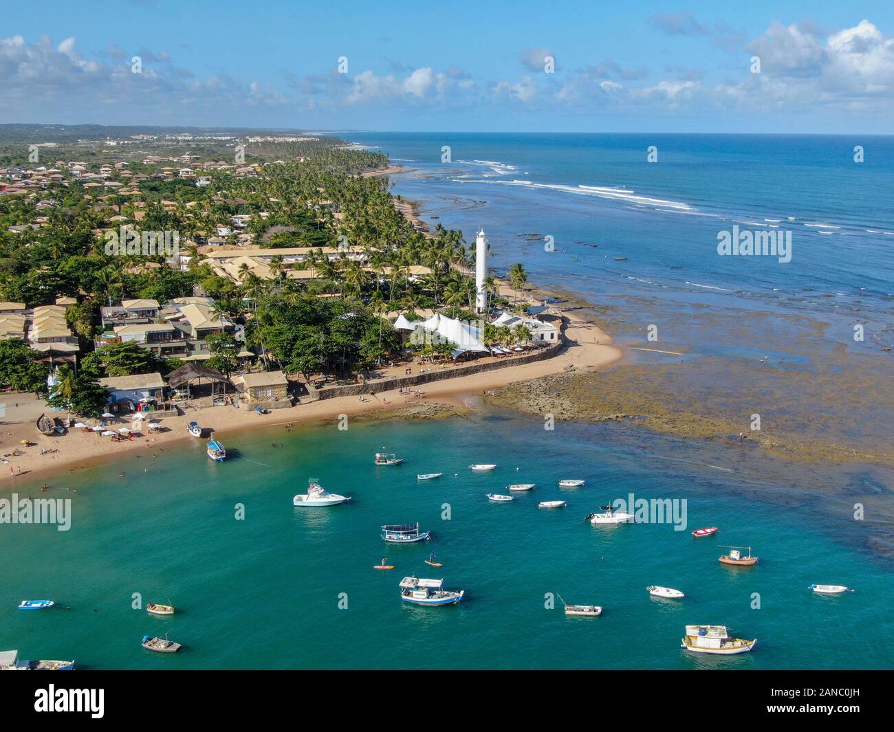Aerial view of Praia Do Forte coastline village with beach and blue ...