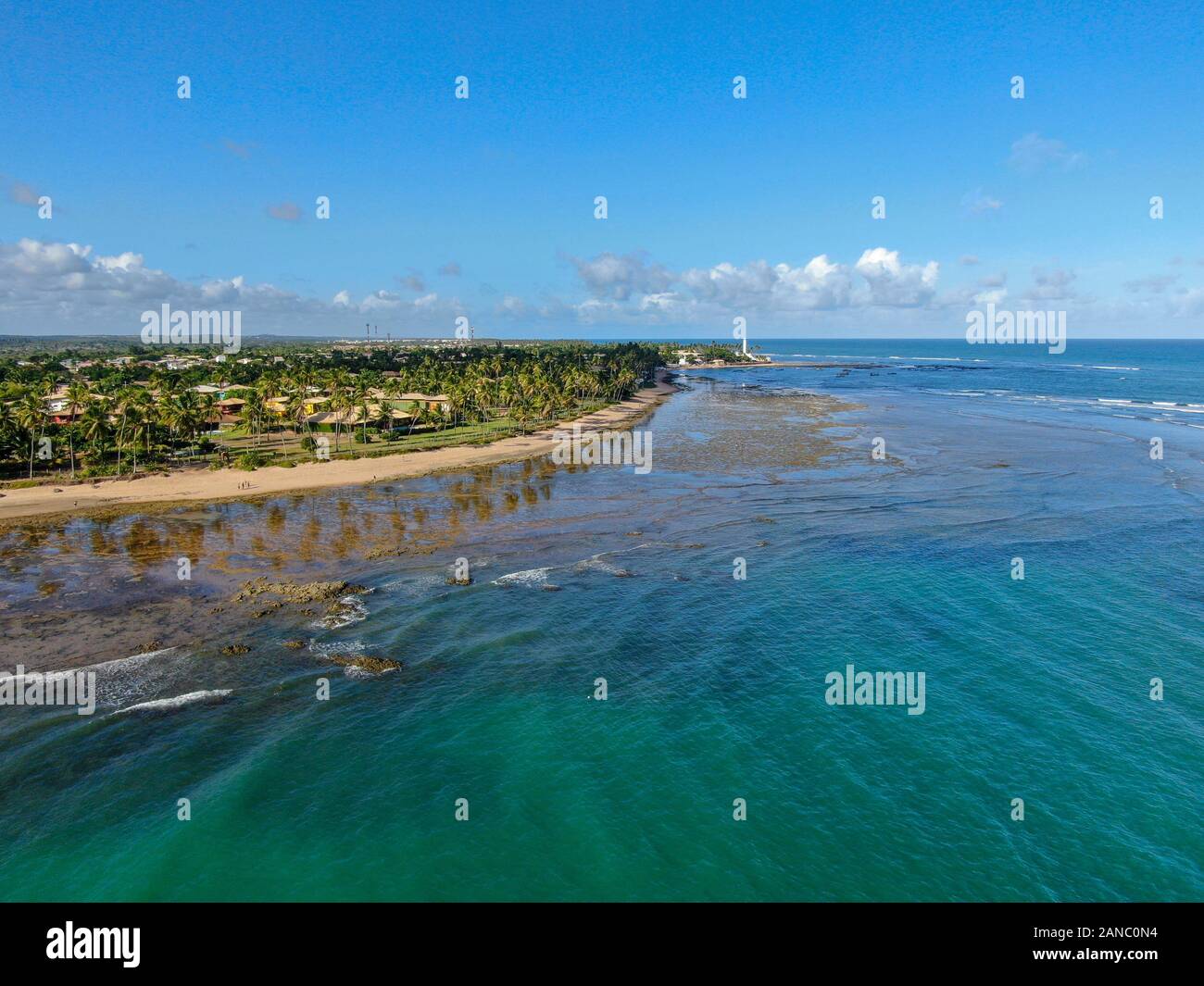 Aerial view of Praia Do Forte coastline village with beach and blue ...