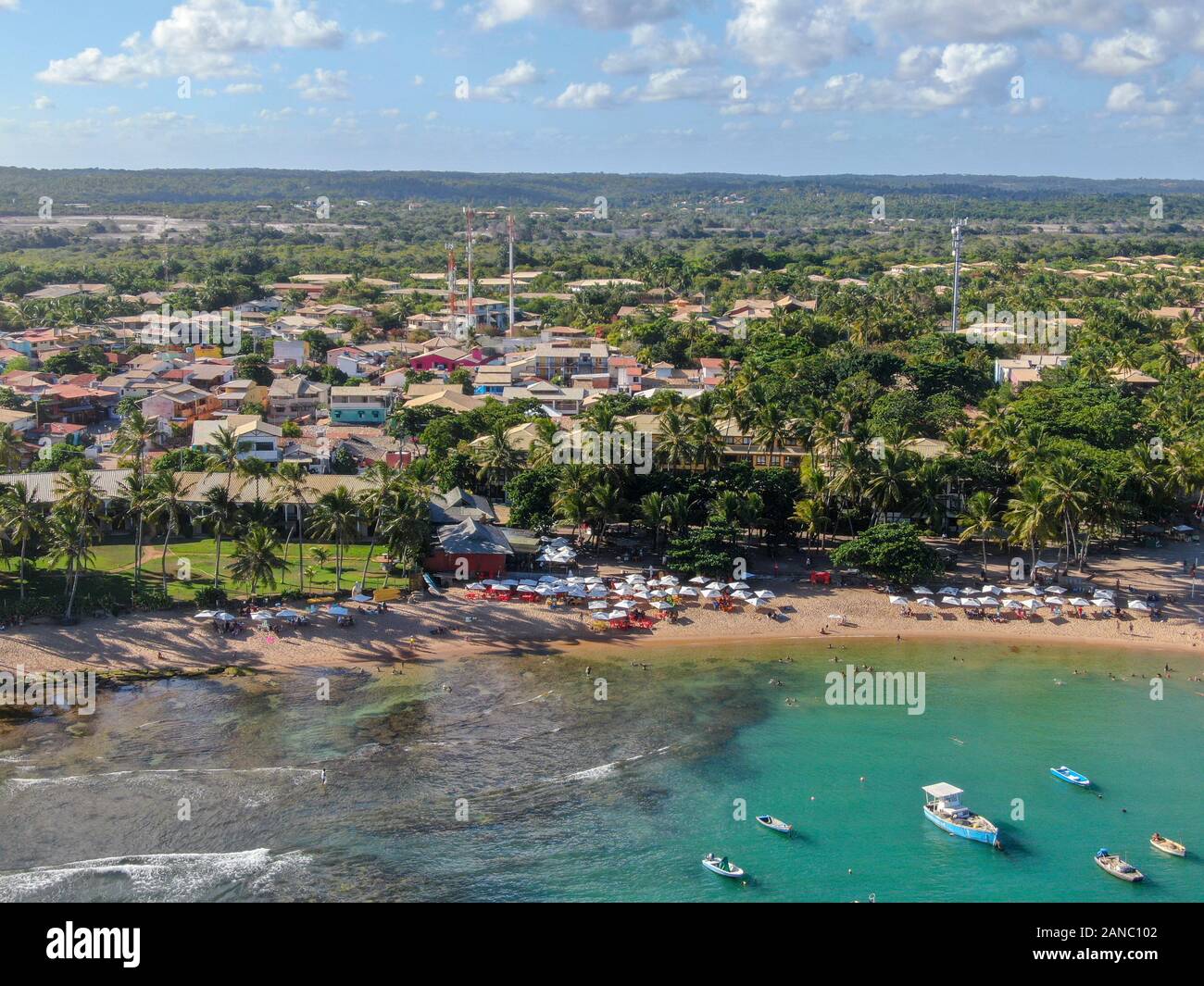 Aerial view of Praia Do Forte coastline village with beach and blue ...