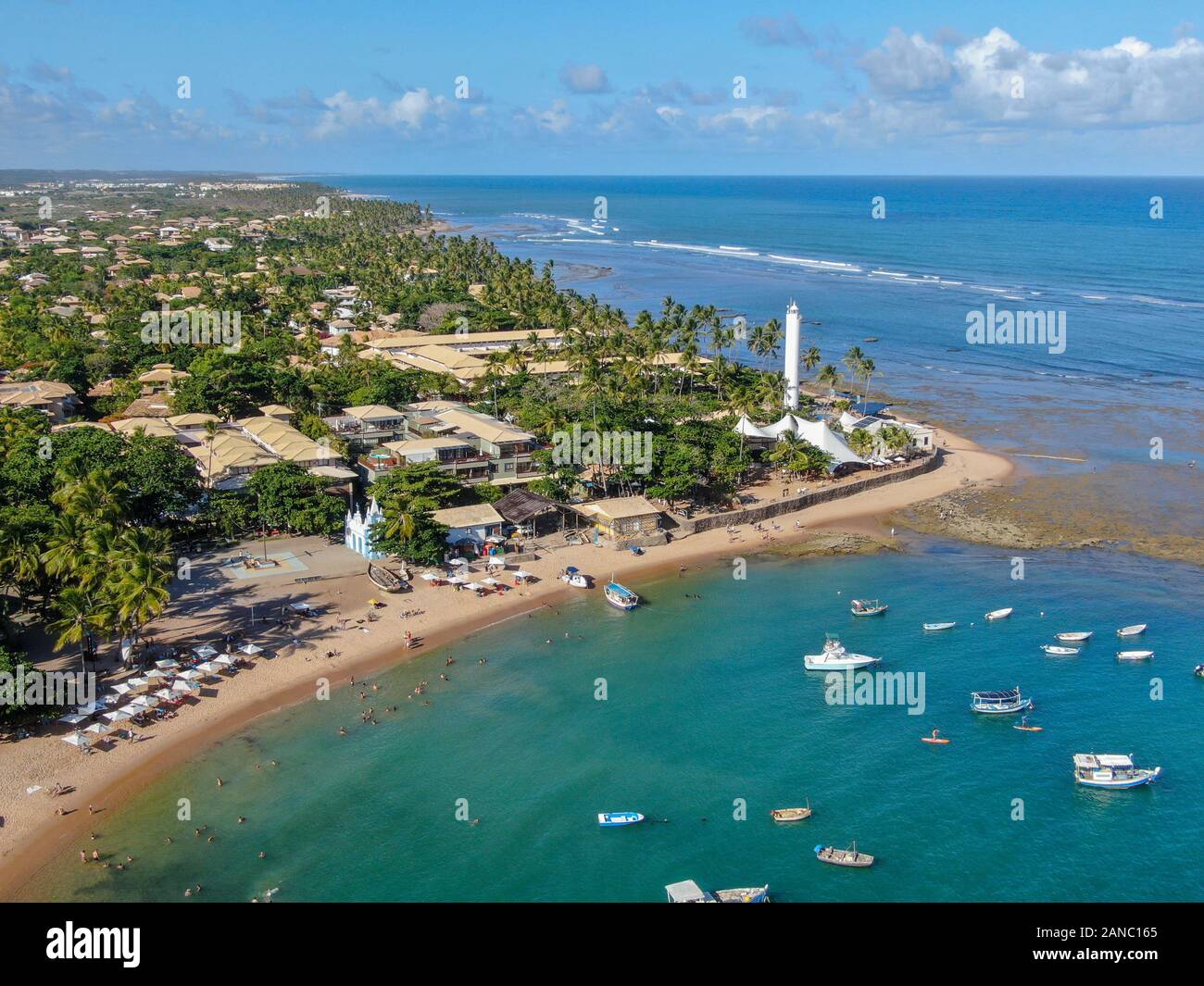 Aerial view of Praia Do Forte coastline village with beach and blue ...