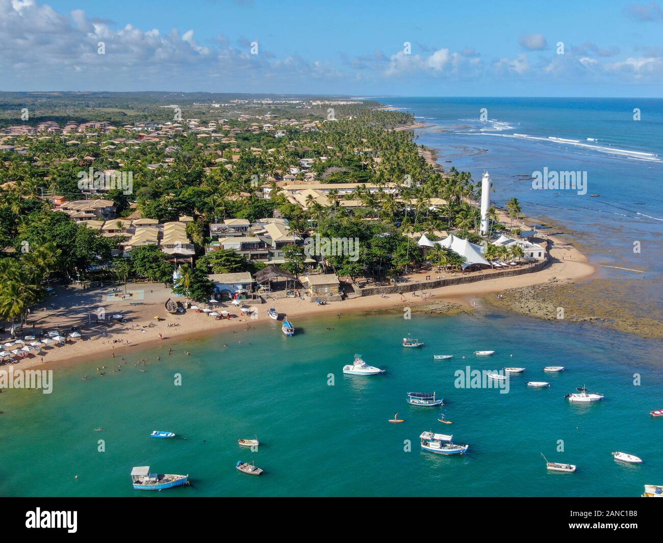 Aerial view of Praia Do Forte coastline village with beach and blue ...