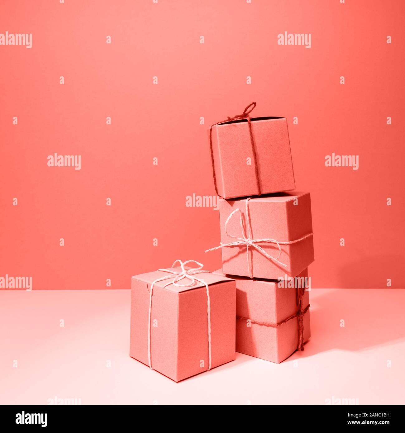 Craft cardboard boxes on the solid pink background. Holiday and gift ...
