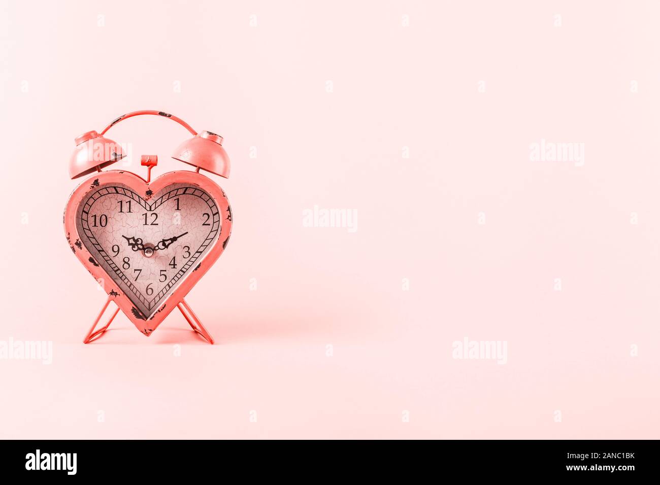 Heart shaped clock on pink background. Valentines day and love infitity ...