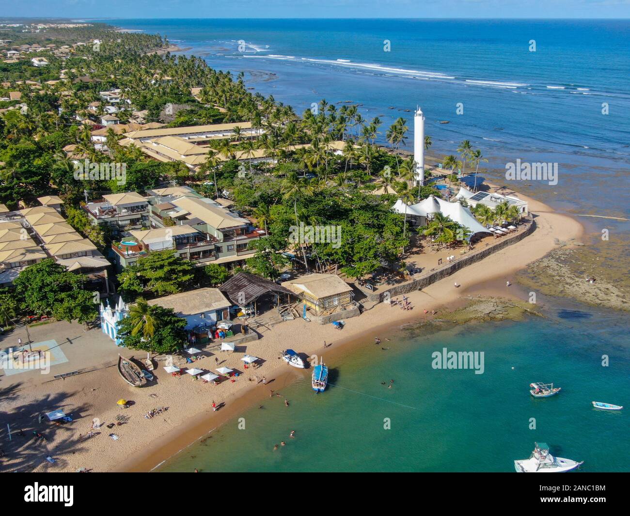 Aerial view of Praia Do Forte coastline village with beach and blue ...