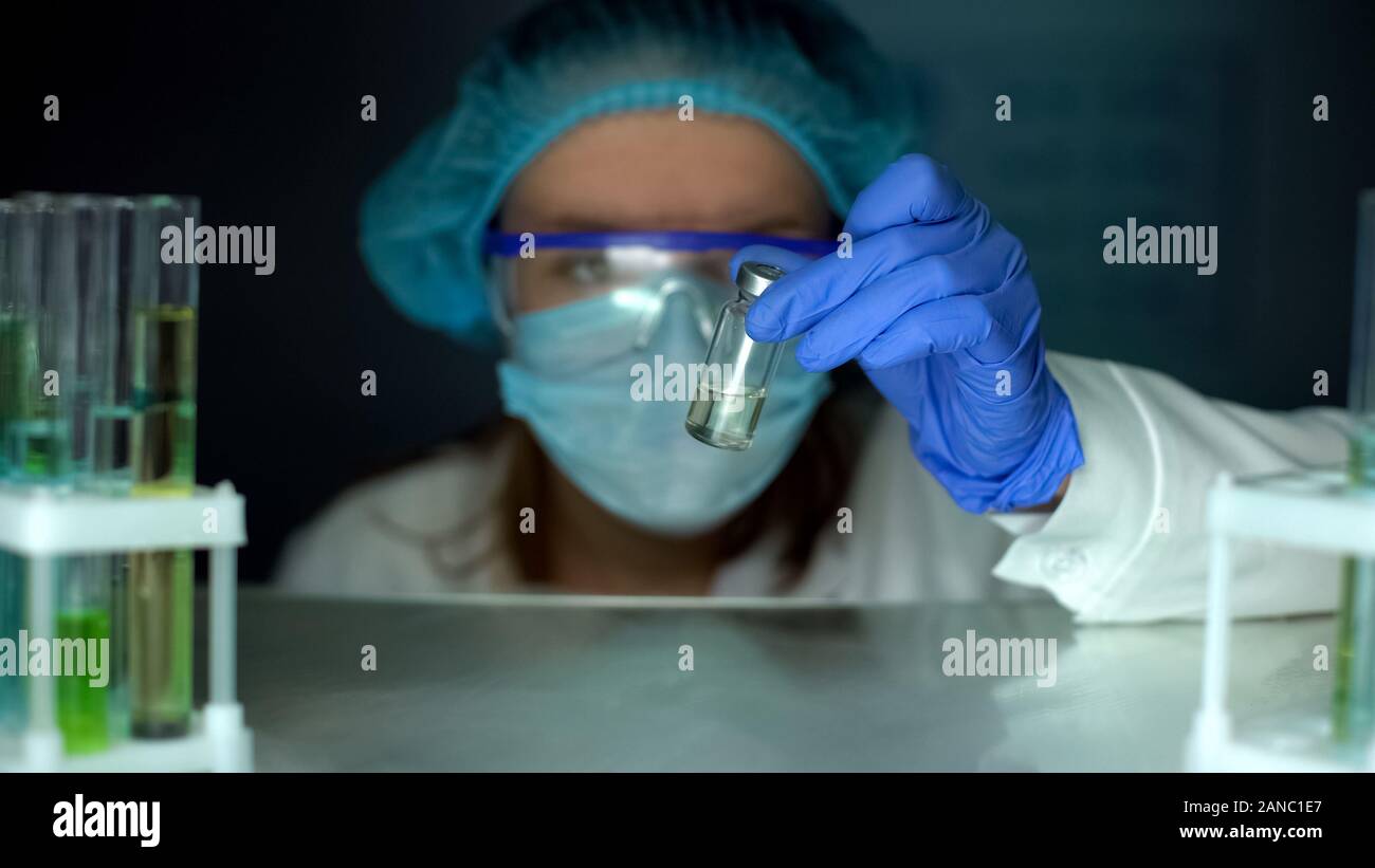 Scientist taking bottle with liquid from fridge, antibiotic development ...