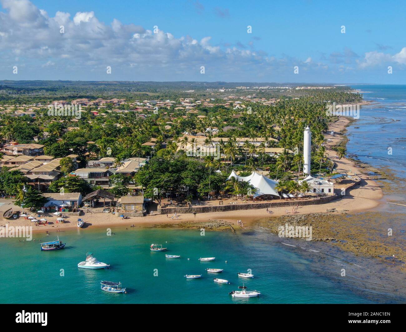Aerial view of Praia Do Forte coastline village with beach and blue ...
