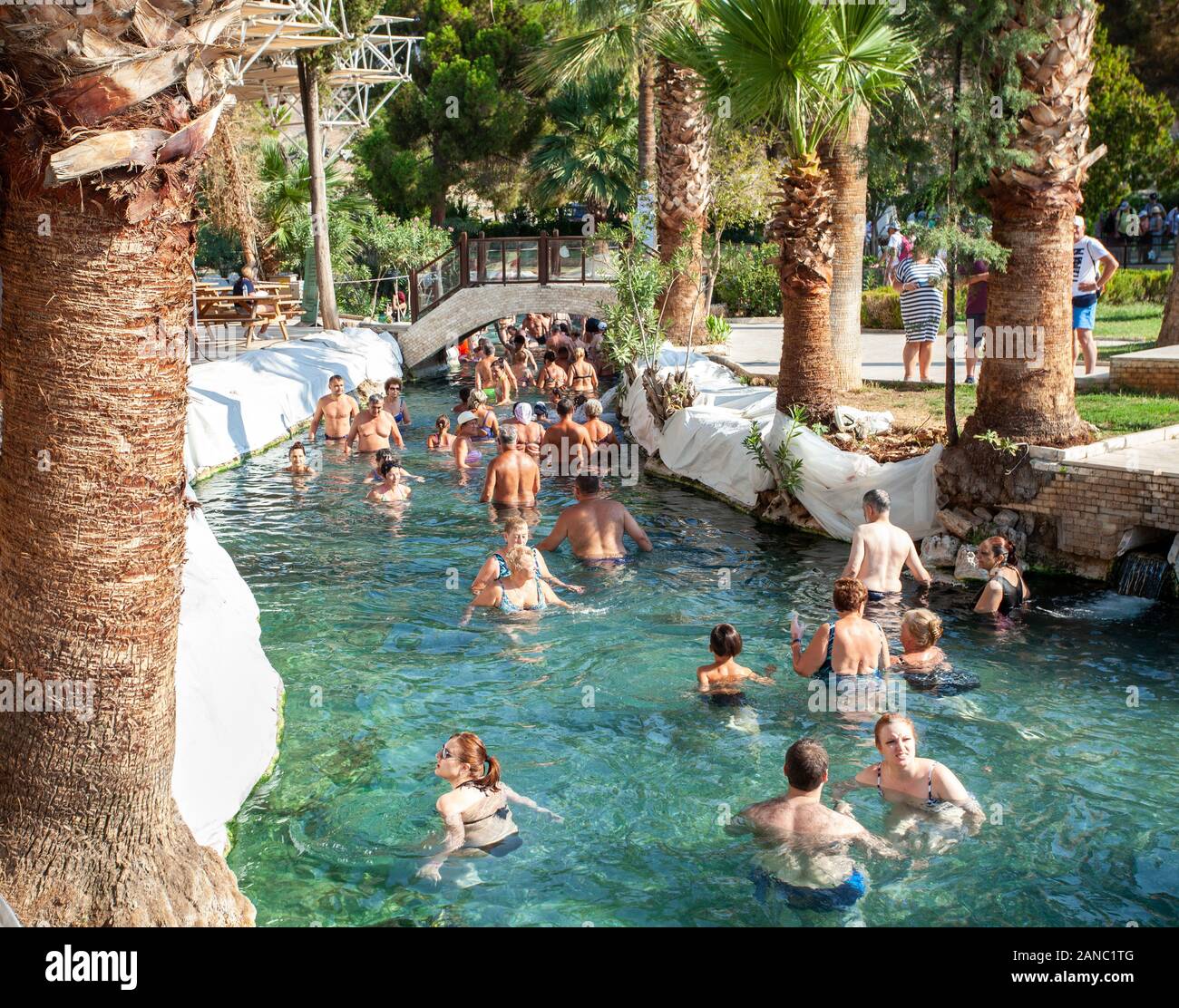 Pamukkale, Turkey- September 7, 2019: Many people walk and swim in the ...