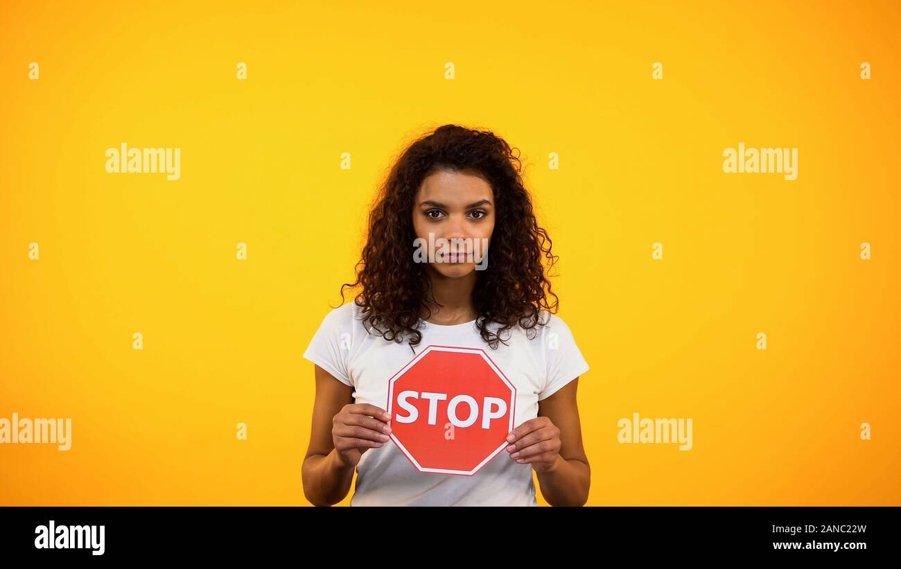 African-American lady showing stop sign, women rights protection ...