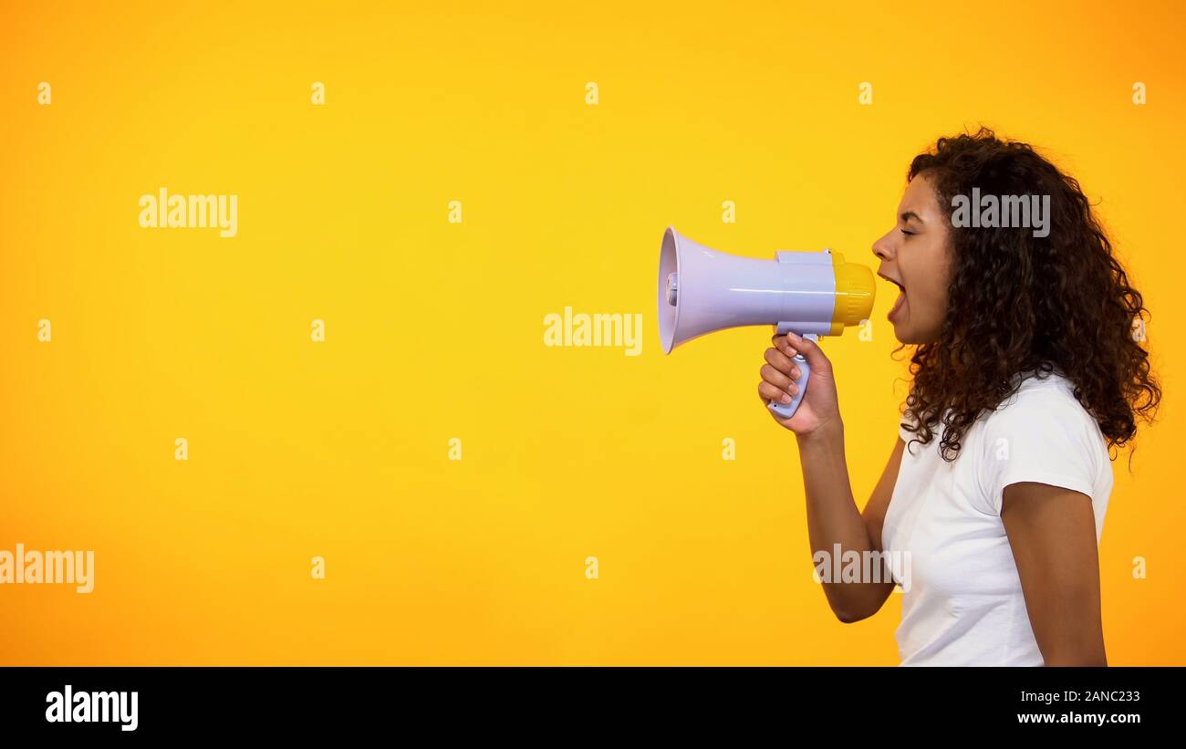 African-American woman with megaphone announcing sensation news, shop ...