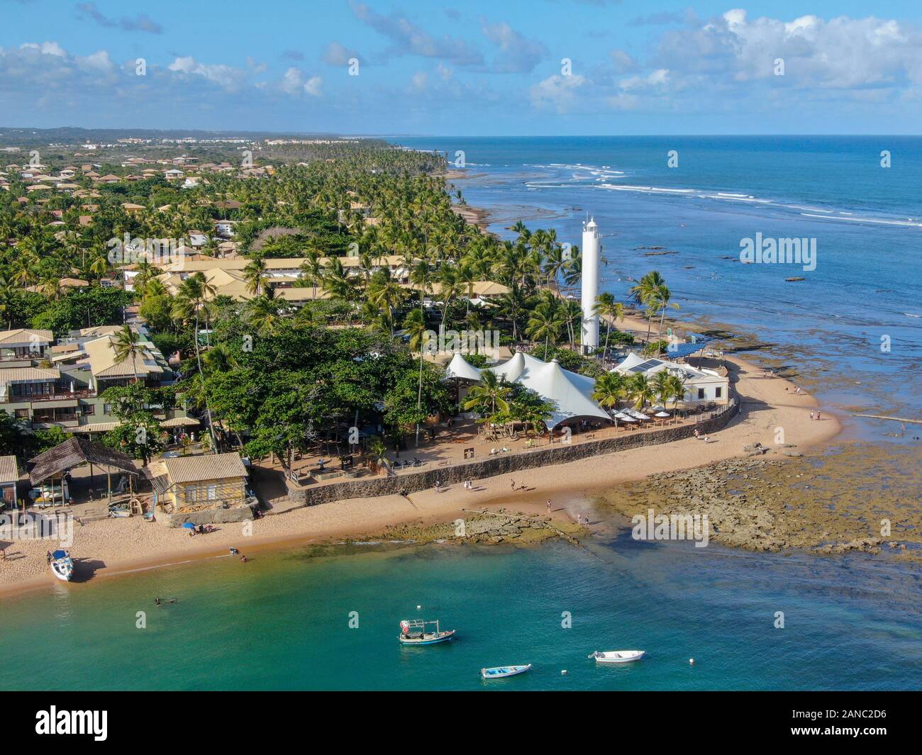 Aerial view of Praia Do Forte coastline village with beach and blue ...