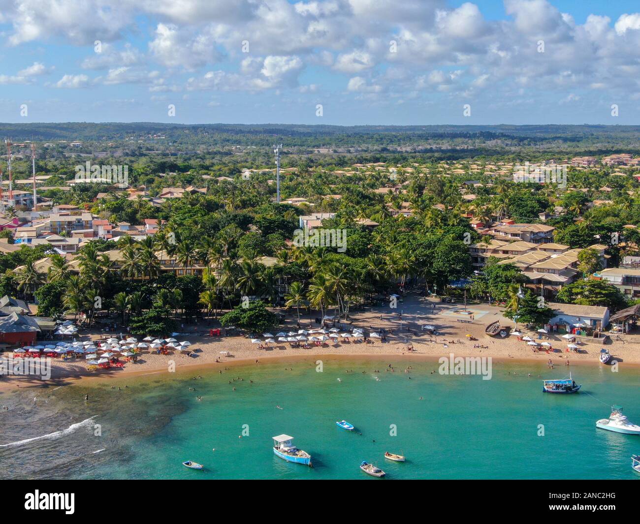 Aerial view of Praia Do Forte coastline village with beach and blue ...