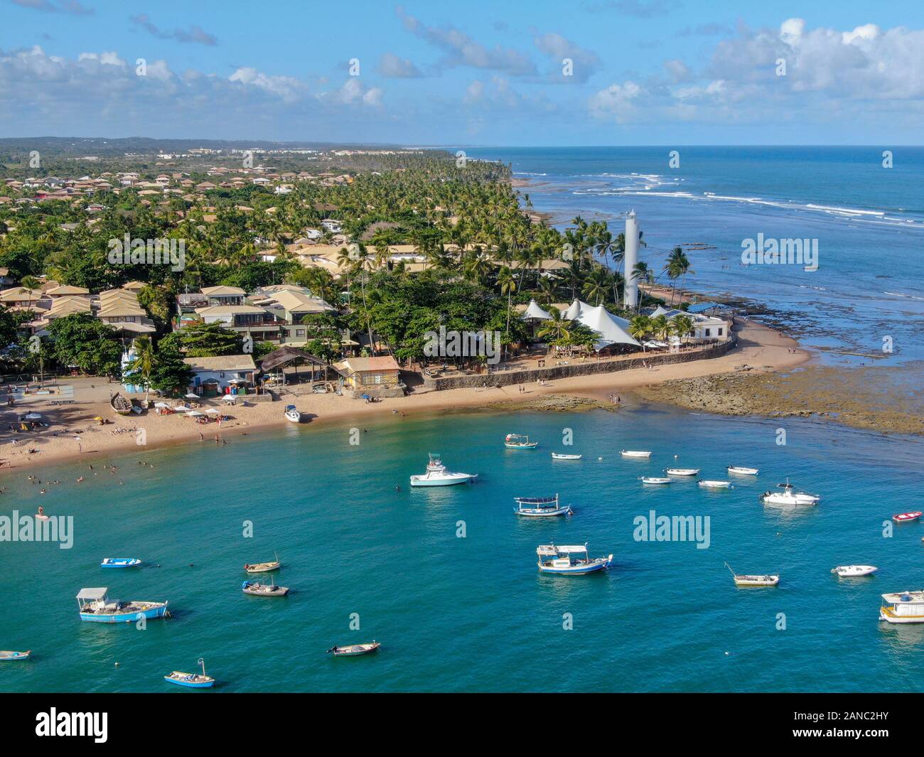Aerial view of Praia Do Forte coastline village with beach and blue ...
