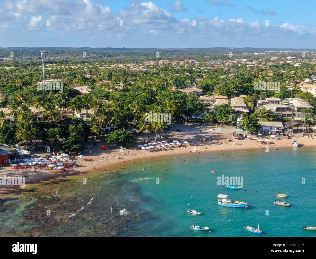 Aerial view of Praia Do Forte coastline village with beach and blue ...